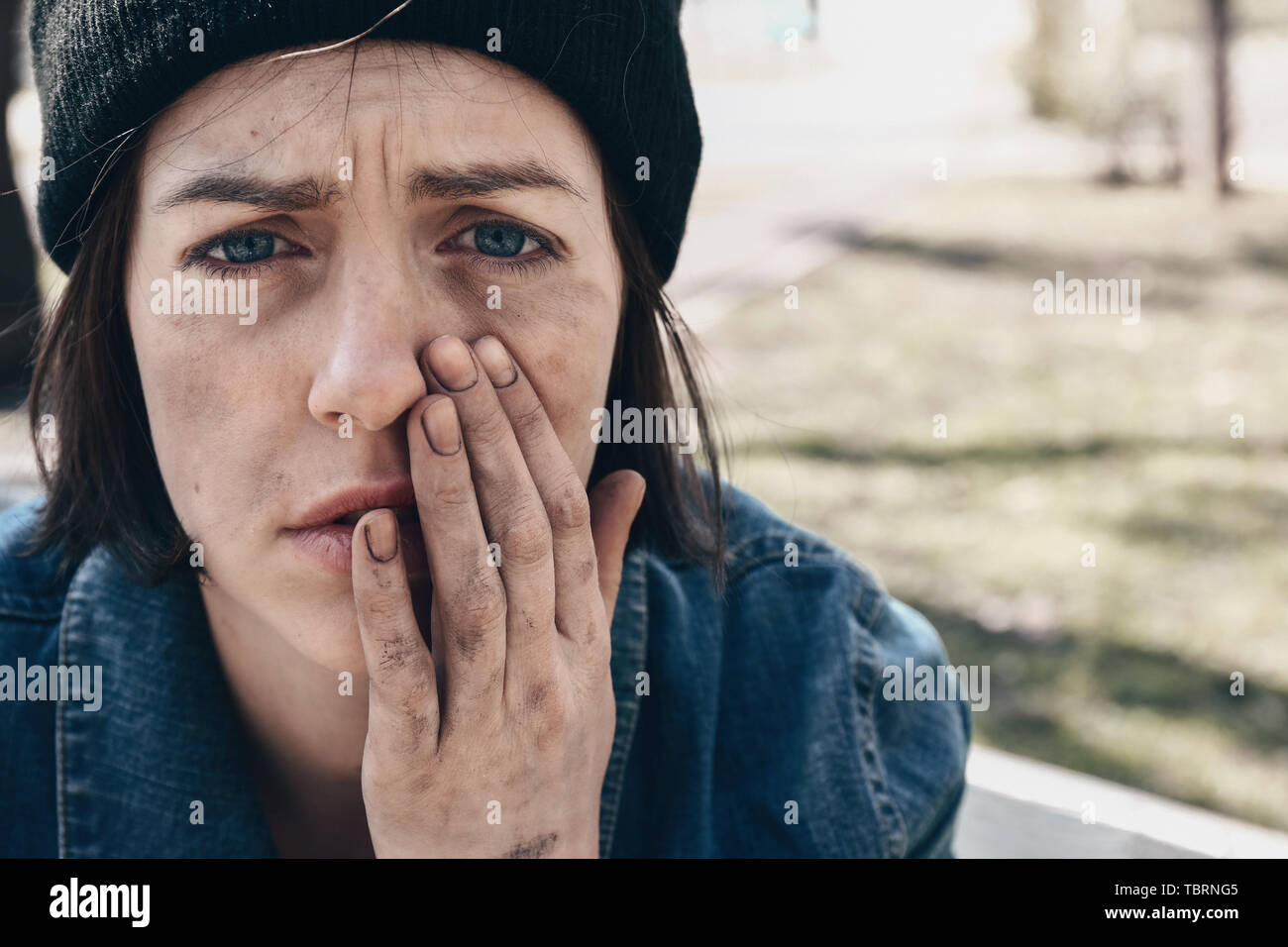 Portrait of sad homeless woman outdoors Stock Photo - Alamy