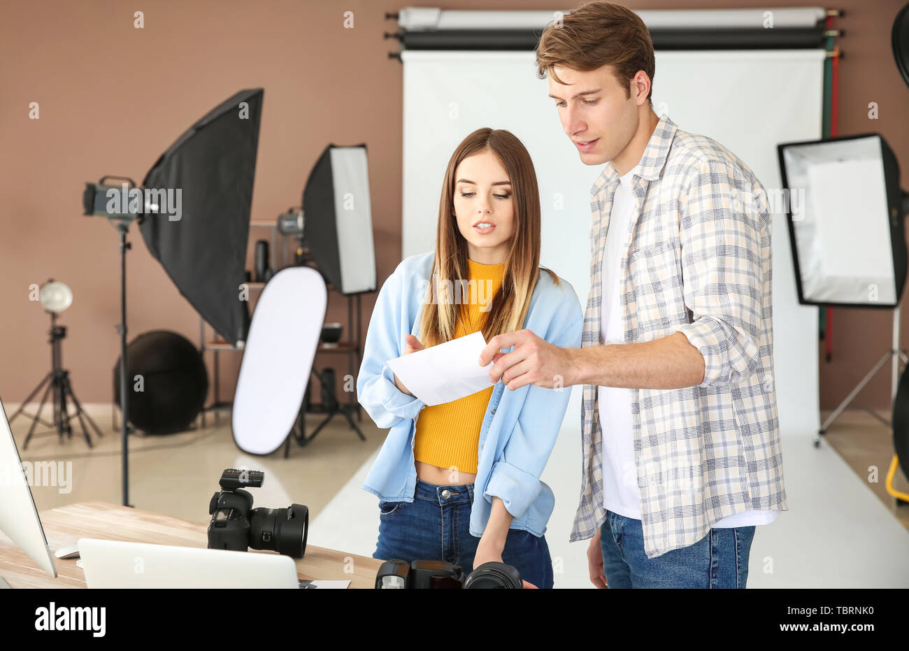 Professional photographers discussing pictures in modern studio Stock ...