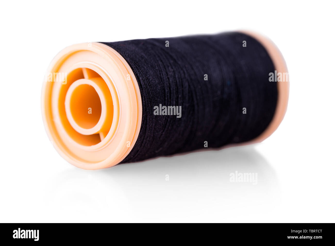 bobbin with black thread on a white background Stock Photo - Alamy