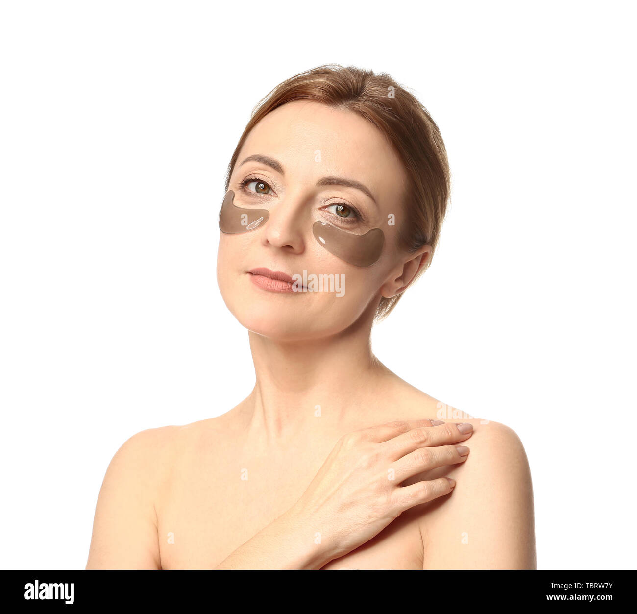 Mature woman with under-eye patches on white background Stock Photo - Alamy