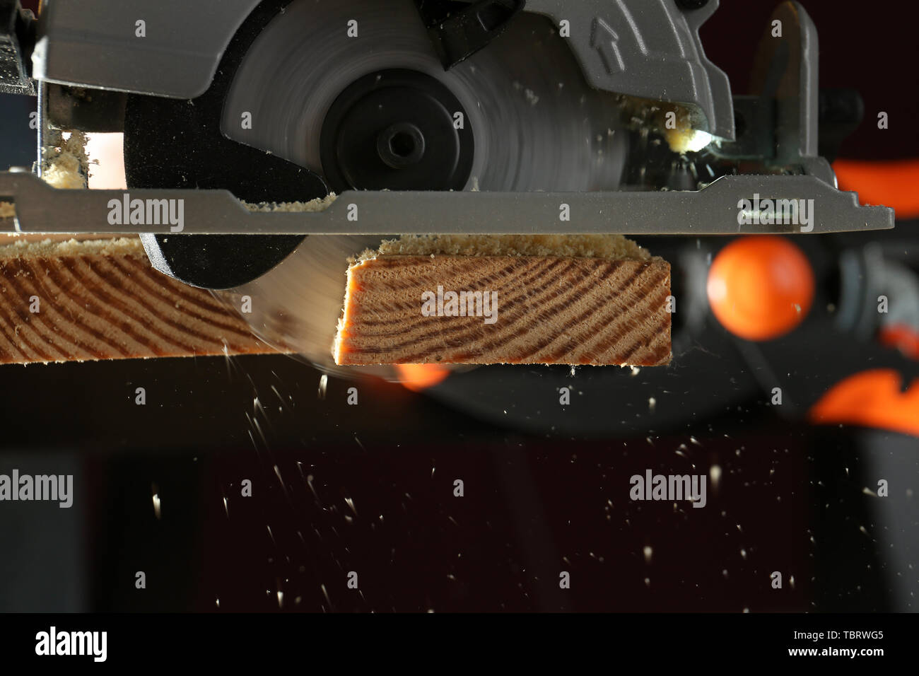 Cutting of wooden plank in carpenter's workshop, closeup Stock Photo ...