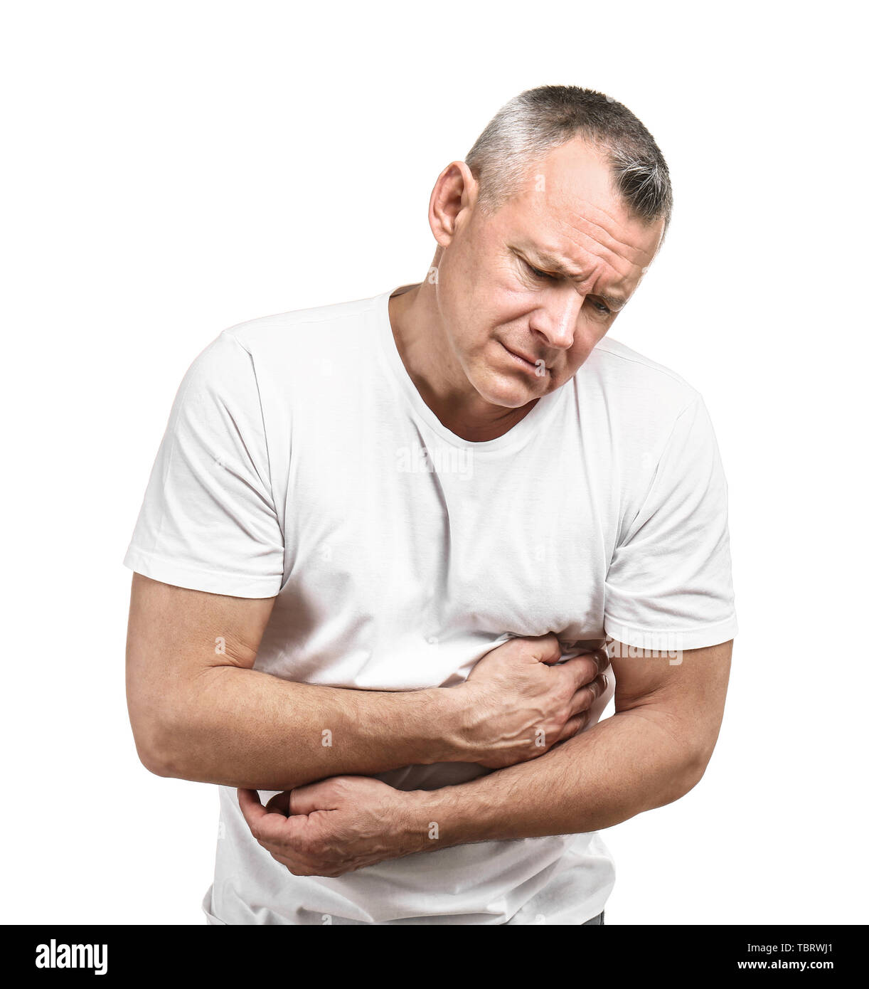 Handsome middle-aged man suffering from stomach pain on white ...