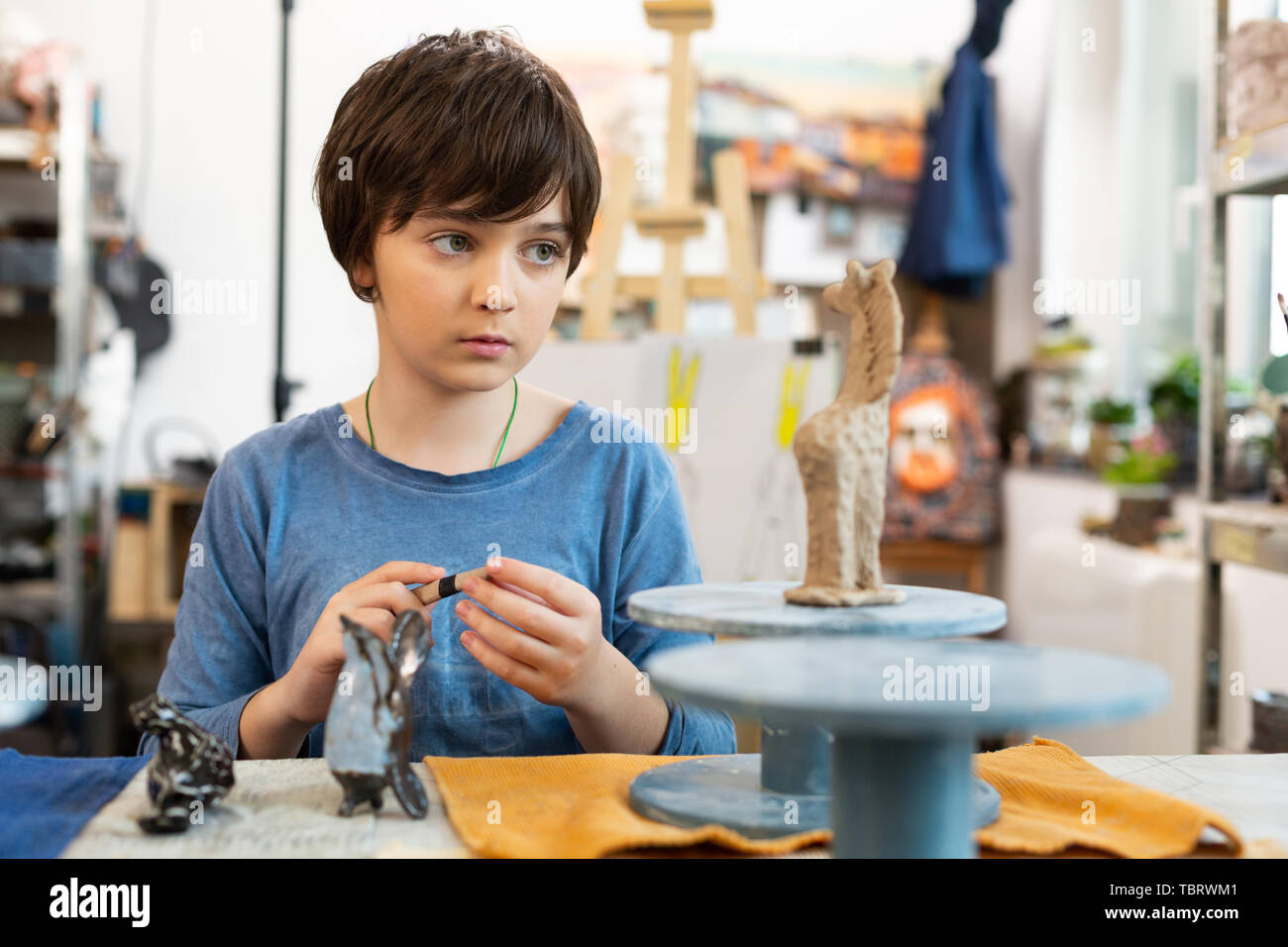 Little clay animal. Cute handsome talented and creative boy sculpting ...