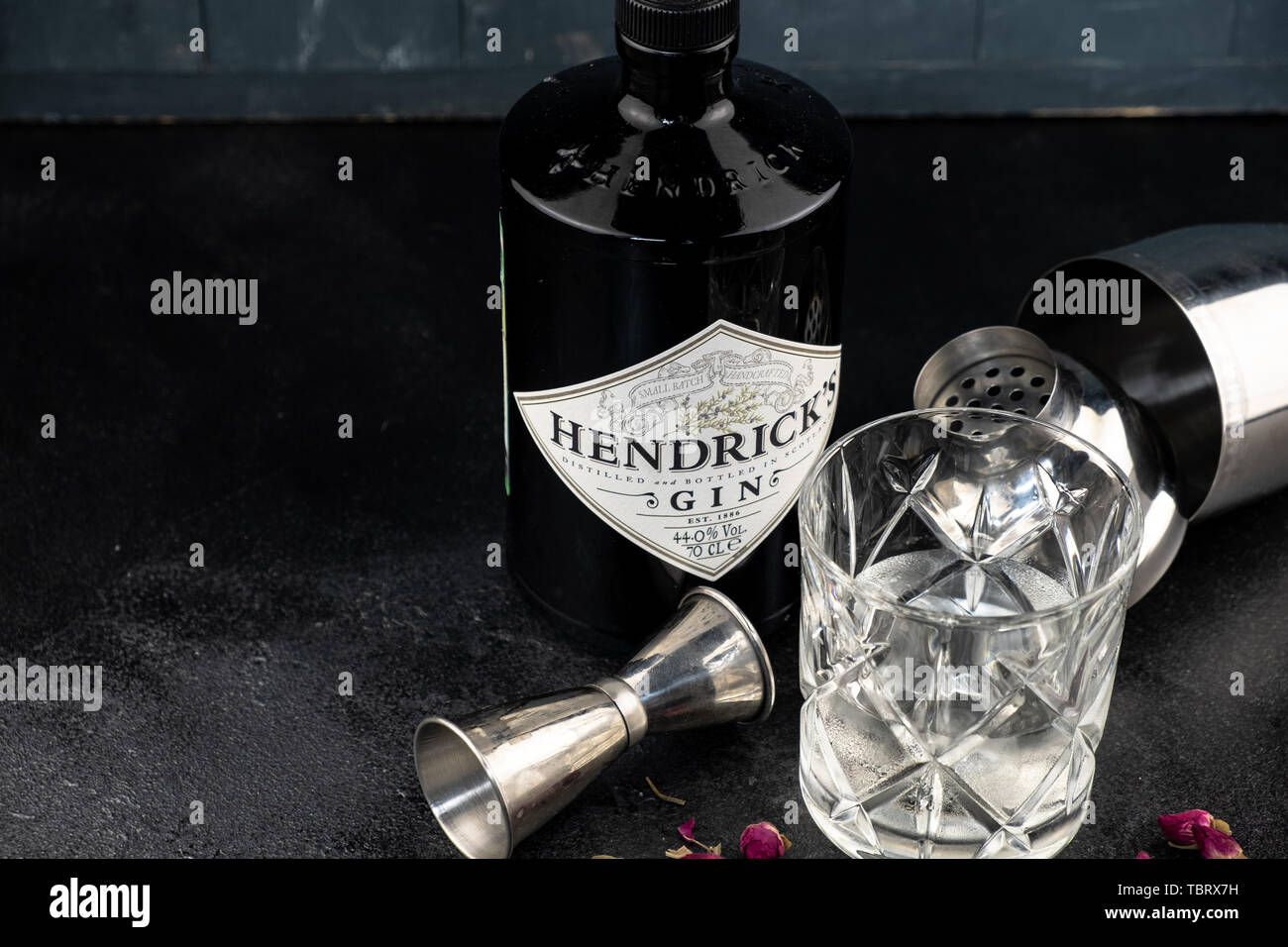 70 cl bottle Hendricks distilled gin with glass and ice on dark rustic ...