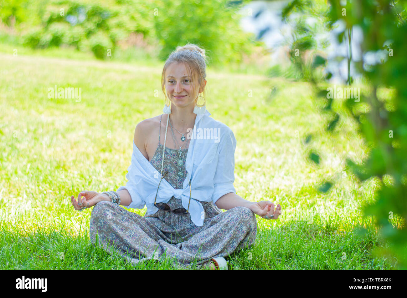 Hippy woman meditating hi-res stock photography and images - Alamy