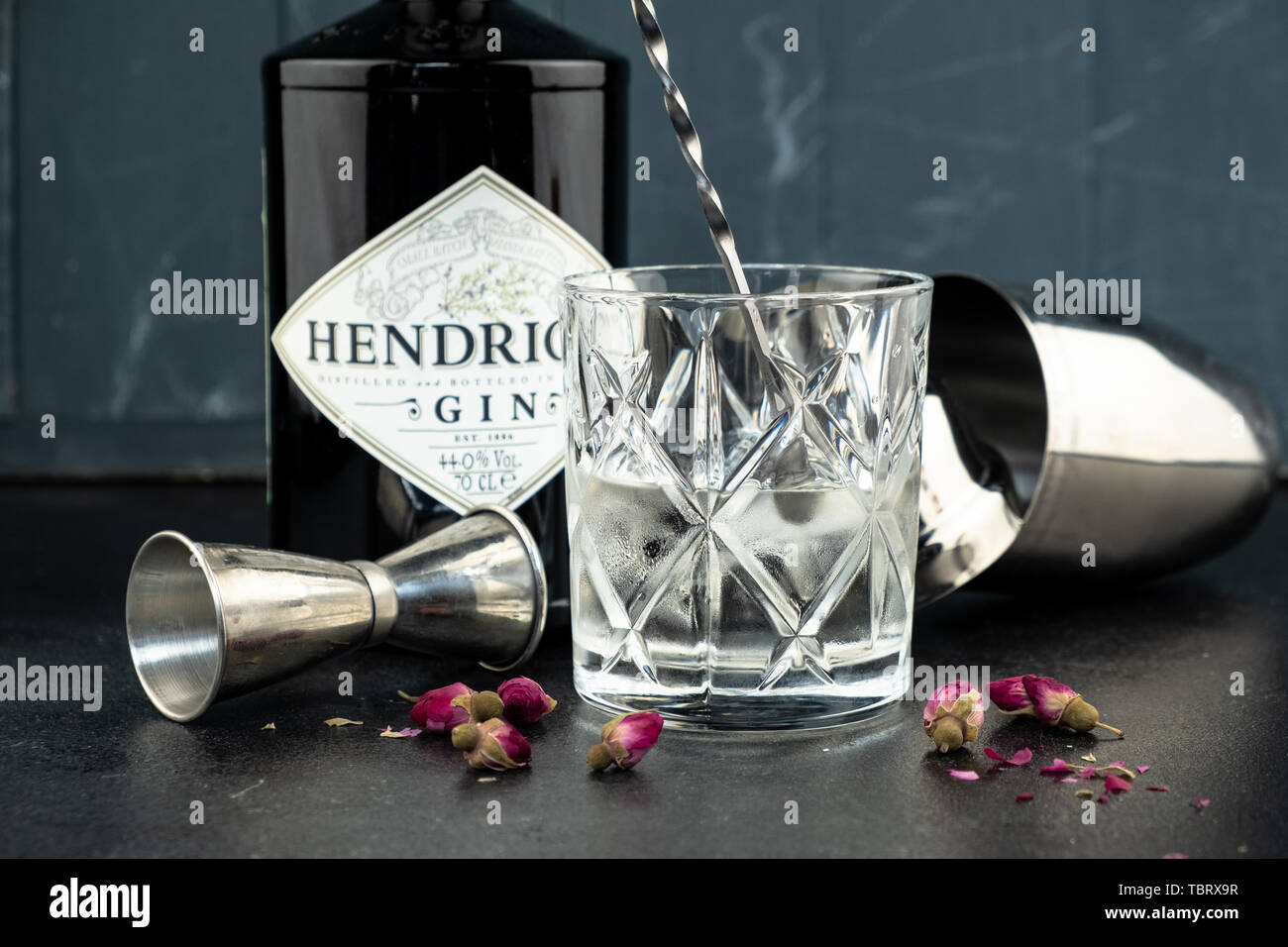 70 cl bottle Hendricks distilled gin with glass and ice on dark rustic ...