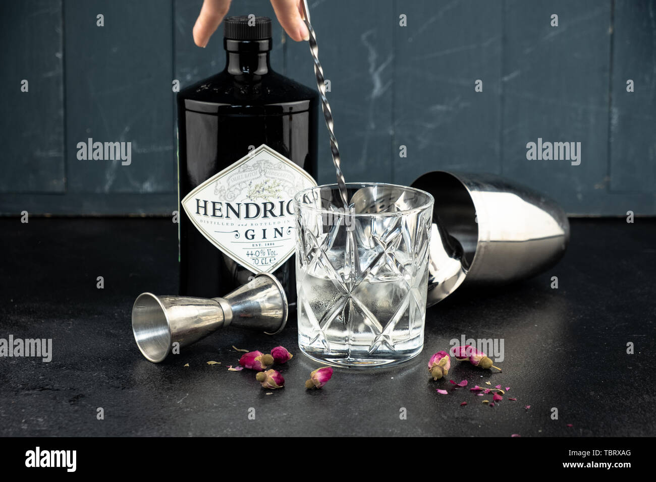 70 cl bottle Hendricks distilled gin with glass and ice on dark rustic ...