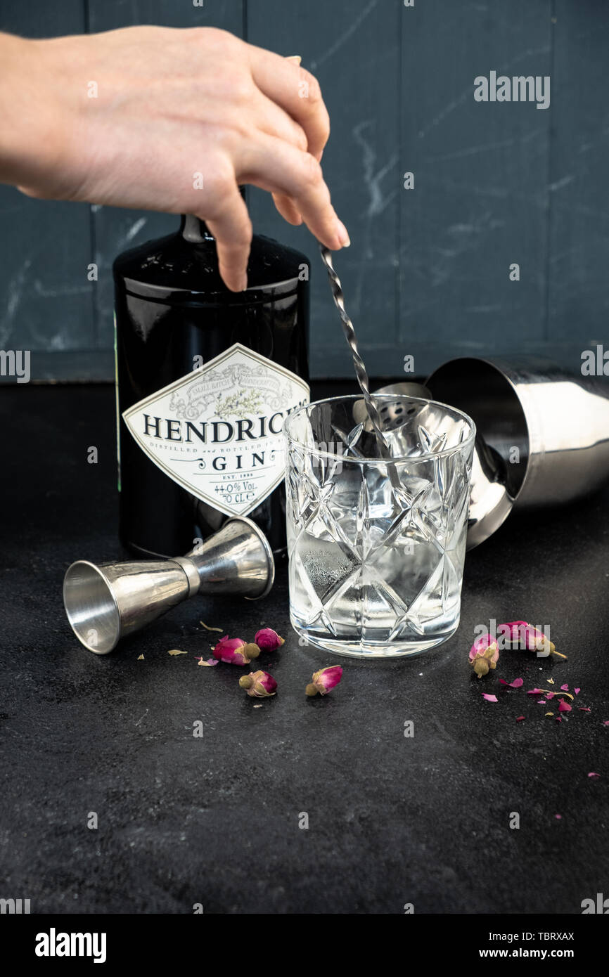 70 cl bottle Hendricks distilled gin with glass and ice on dark rustic ...