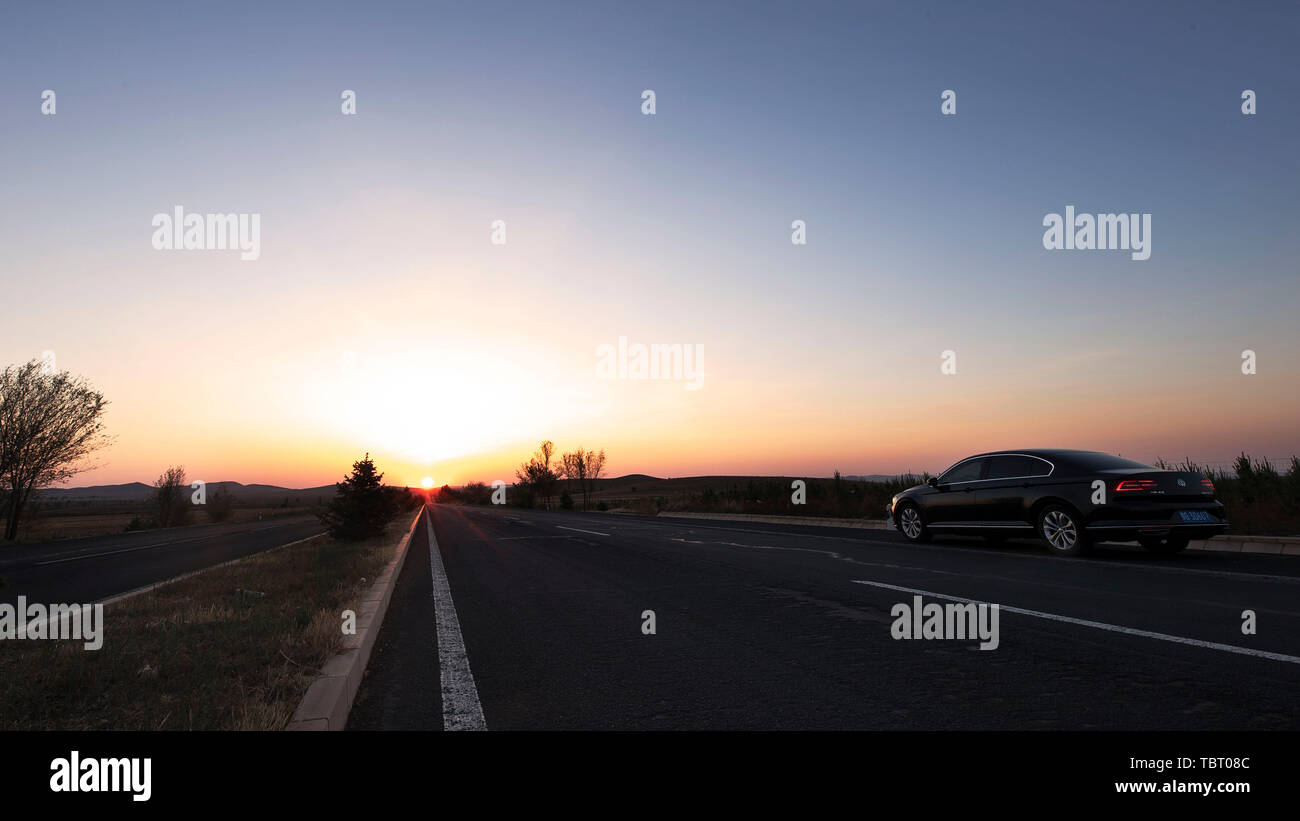 Prairie highway sunrise Stock Photo - Alamy
