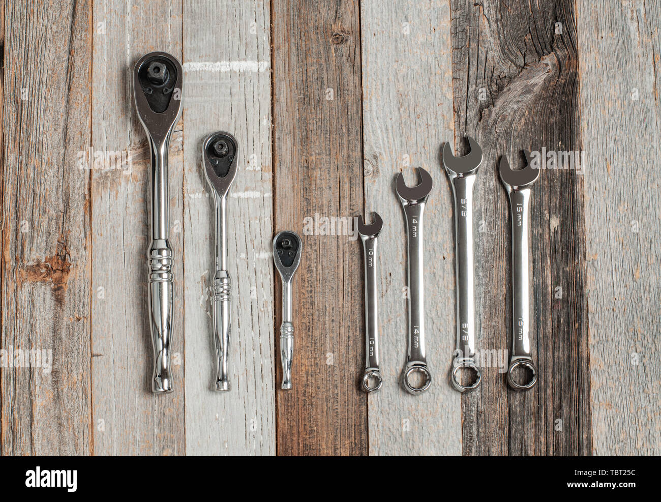 Tools, set wrenches on a wood background. Top view Stock Photo - Alamy