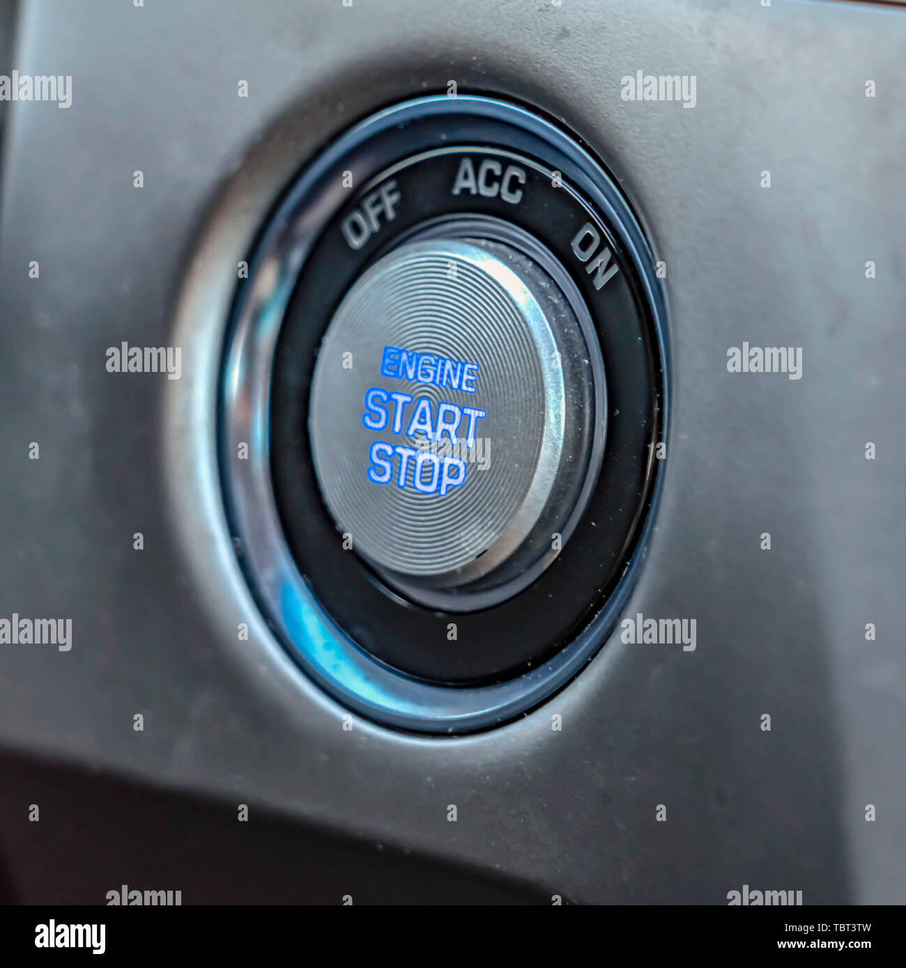 Square Close up view of an engine push start and stop button inside a ...