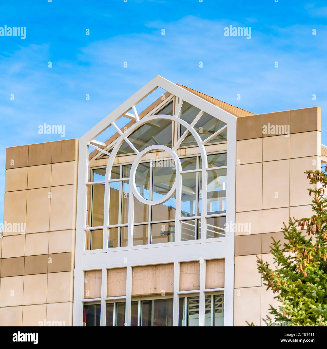 Square frame Building exterior with view of the accent glass wall and ...