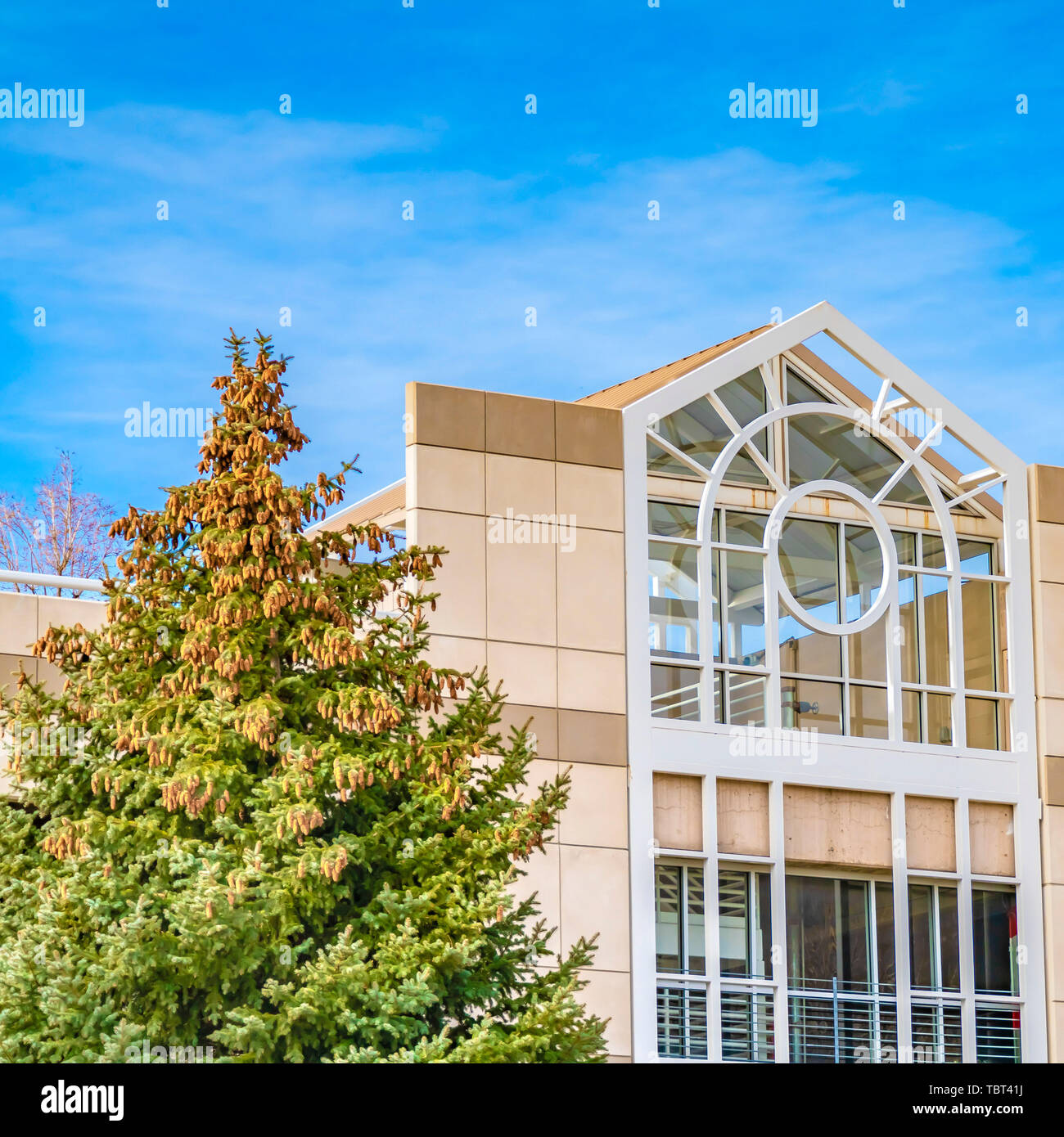 Square Building exterior with view of the accent glass wall and covered ...