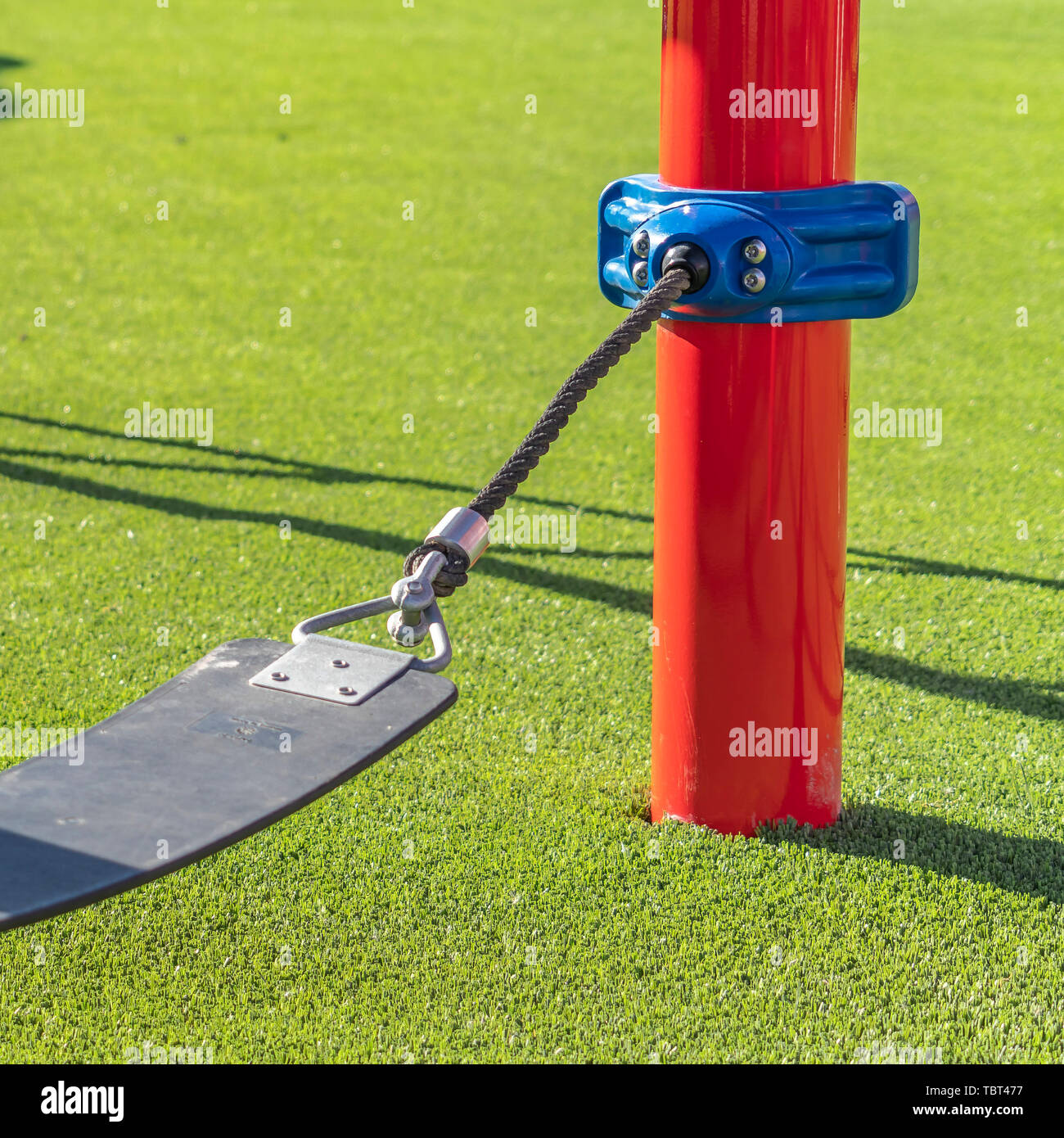 Square frame Play area with a seat supported by ropes that are ...