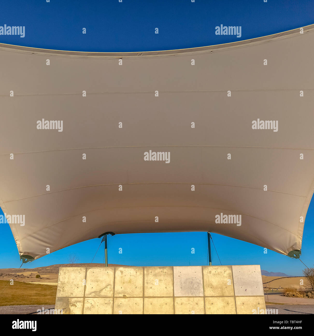 Square Concrete rectangular structure under a white canopy against ...