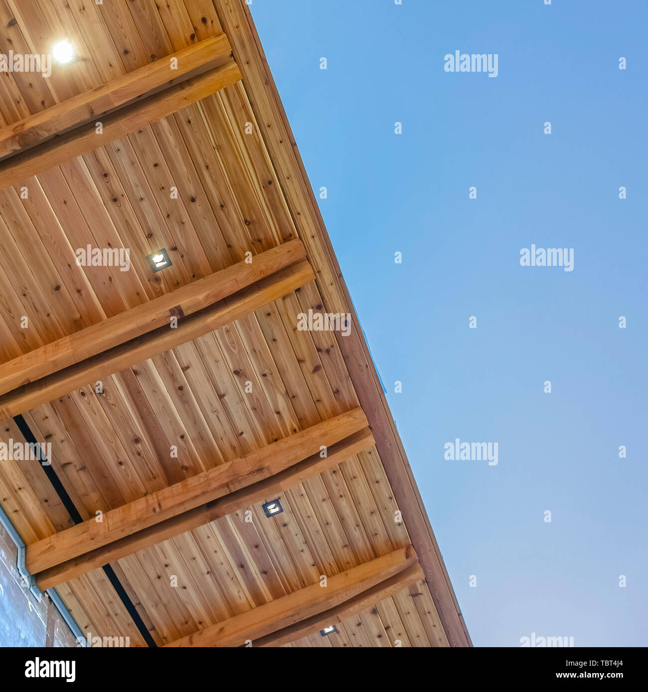 Square The underside of the flat roof of a building with blue sky in ...
