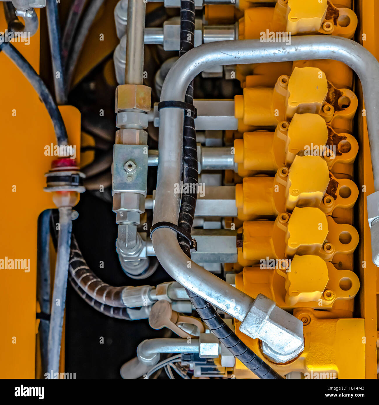 Square frame Details of the engine of a yellow heavy duty construction ...