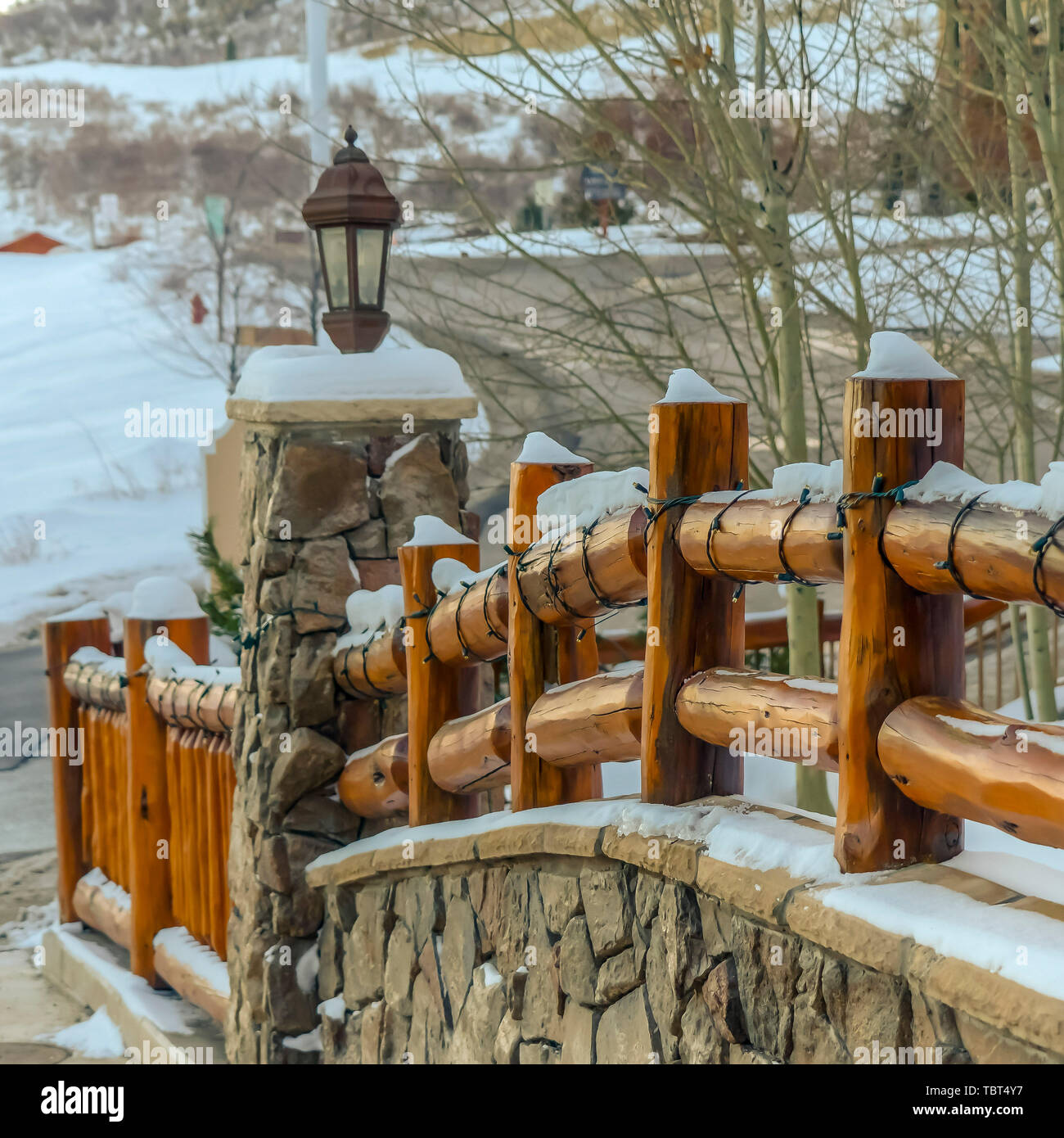 Square Building exterior with stone wall and wooden railing decorated ...