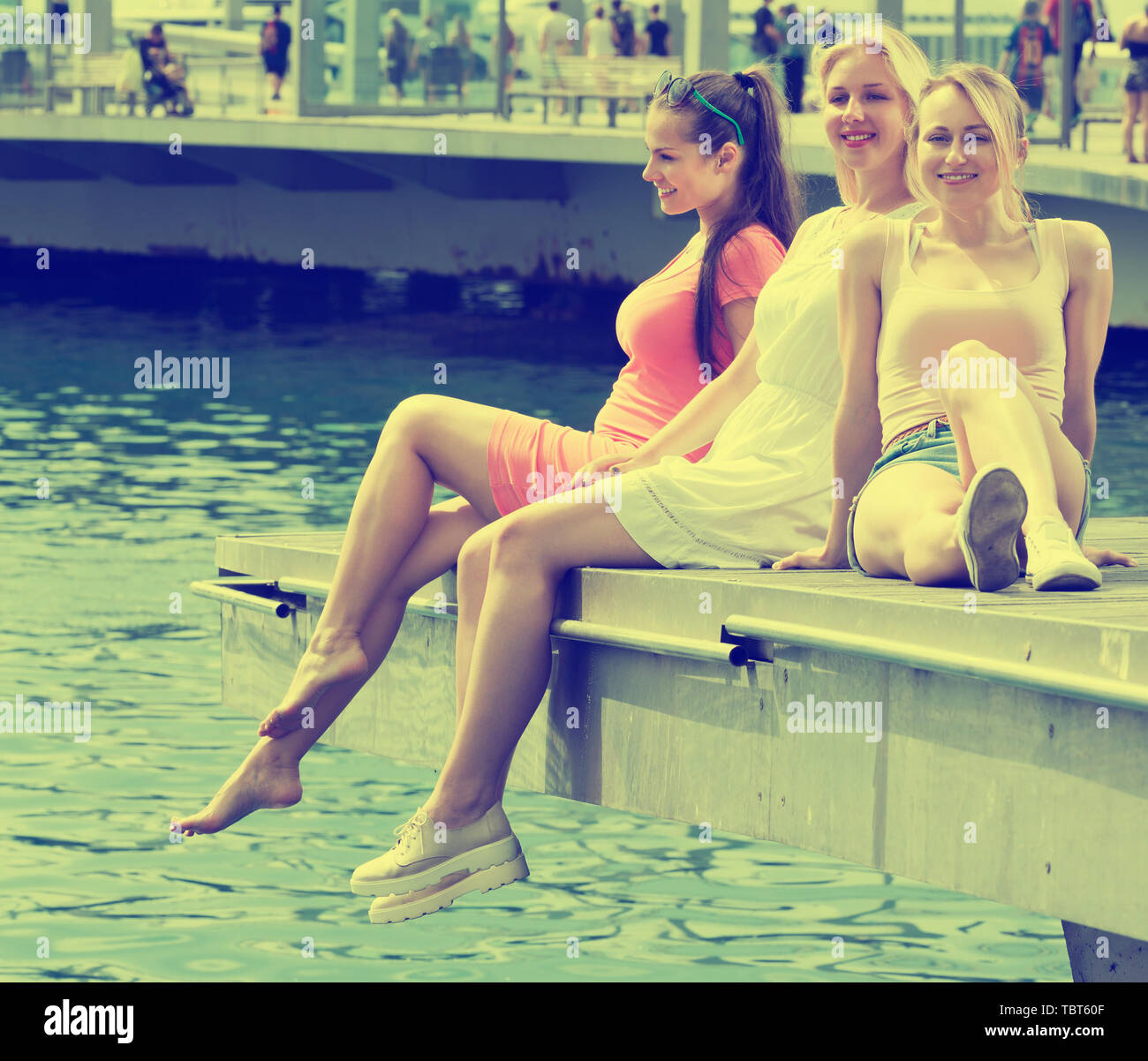 Portrait of three young girls resting at mediterian seaside in harbour ...