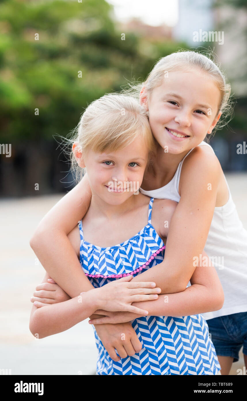 Two small happy sisters fun spending time together outdoors Stock Photo ...