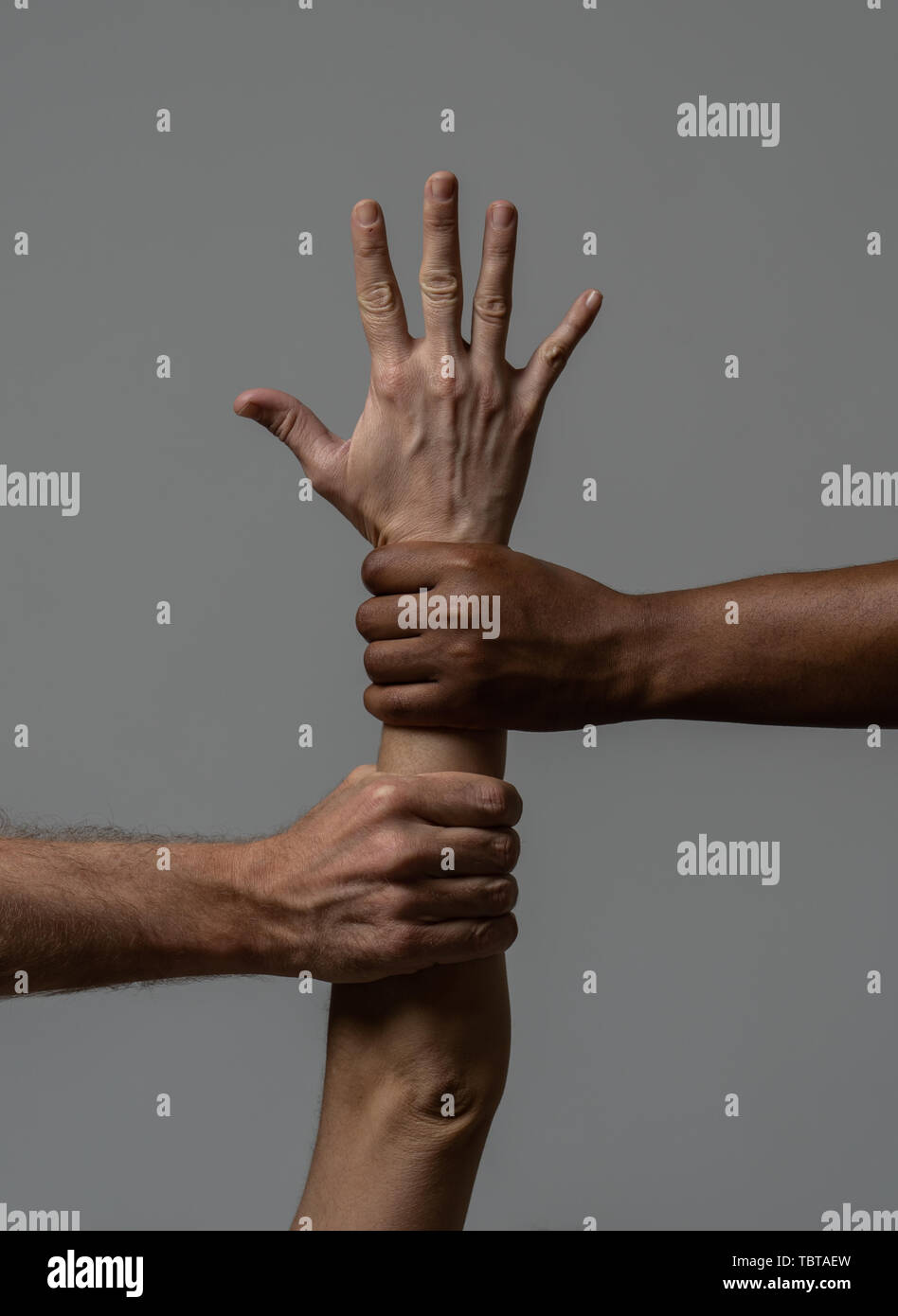 Black African American and Caucasian hands holding together. White and ...