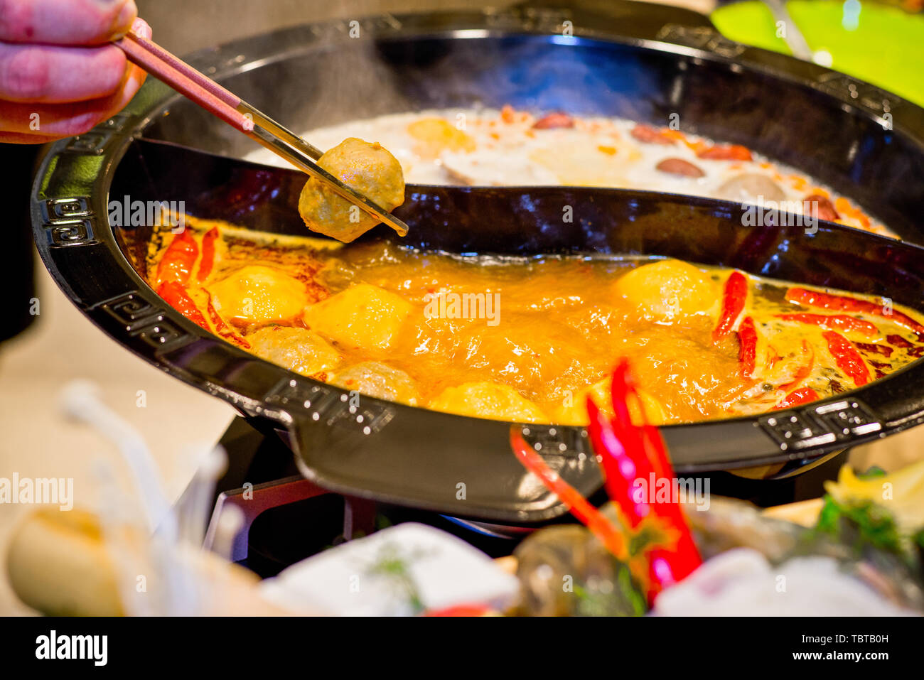 Eat meatballs in a hot pot Stock Photo - Alamy