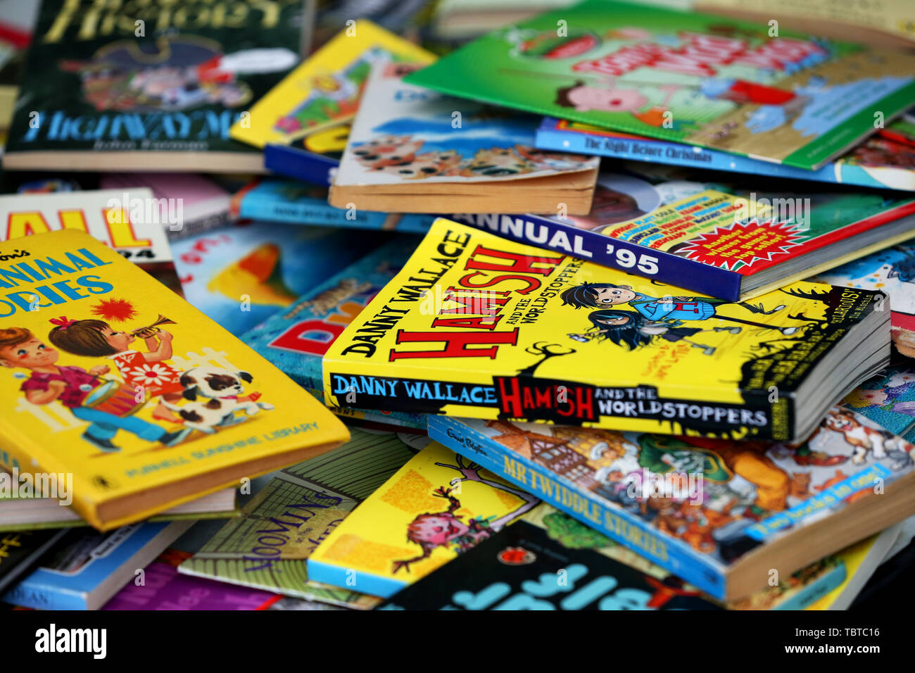 Pile of children's books for sale on a charity stall in Sussex, UK ...