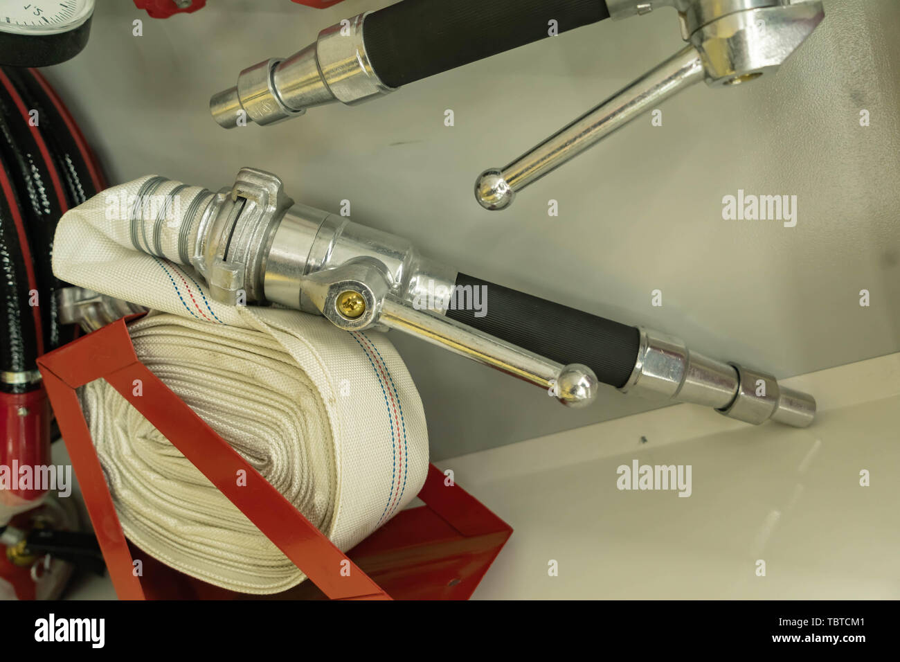Fire shield. Fire hoses, fire hydrants fire hoses Stock Photo - Alamy