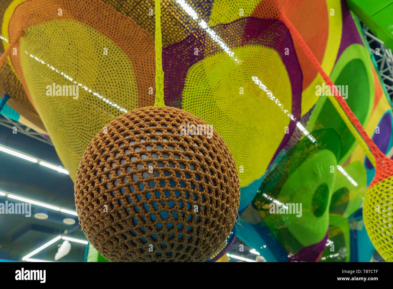 Rubber ball, covered with brown woven mesh. Abstract texture of multi ...