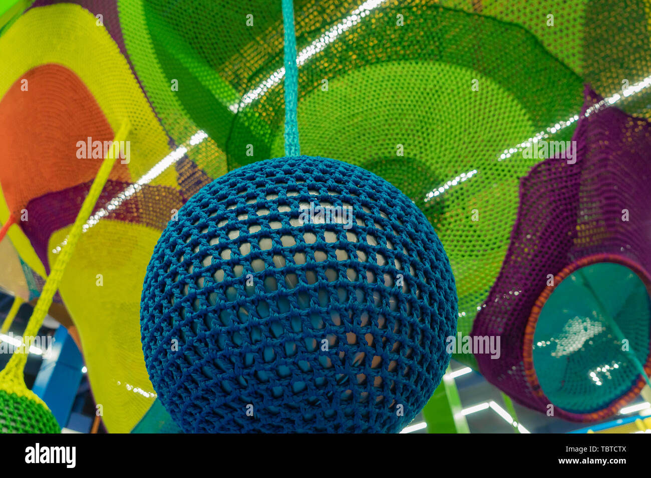 Rubber ball, covered with blue woven mesh. Abstract texture of multi ...