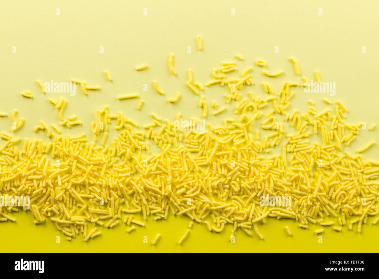Yellow sprinkles on variegated yellow background - Cake topping yellow ...