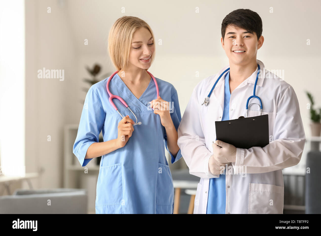 Male doctor and female medical assistant in clinic Stock Photo - Alamy