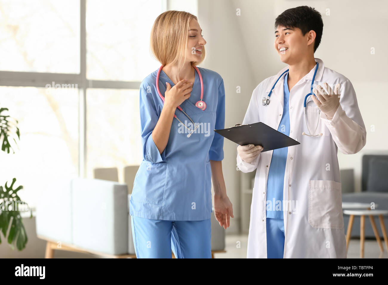 Male doctor and female medical assistant in clinic Stock Photo - Alamy