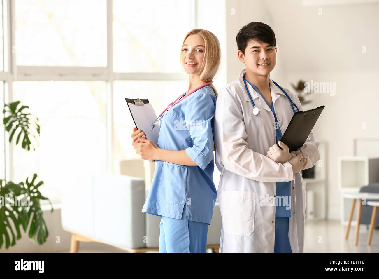 Male doctor and female medical assistant in clinic Stock Photo - Alamy