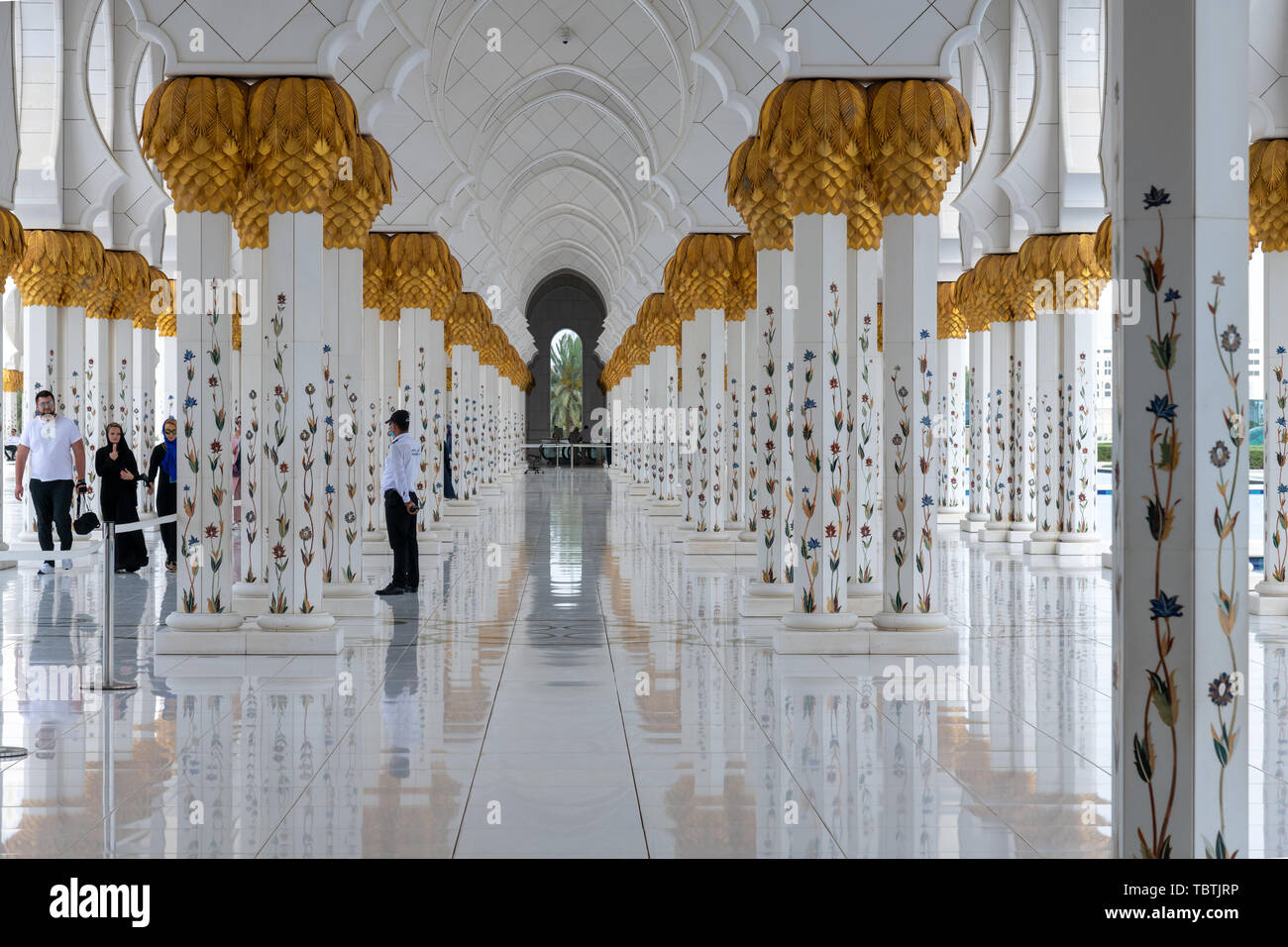 Abu Dhabi, UAE - March 31. 2019. People in Colonnade with floral ...