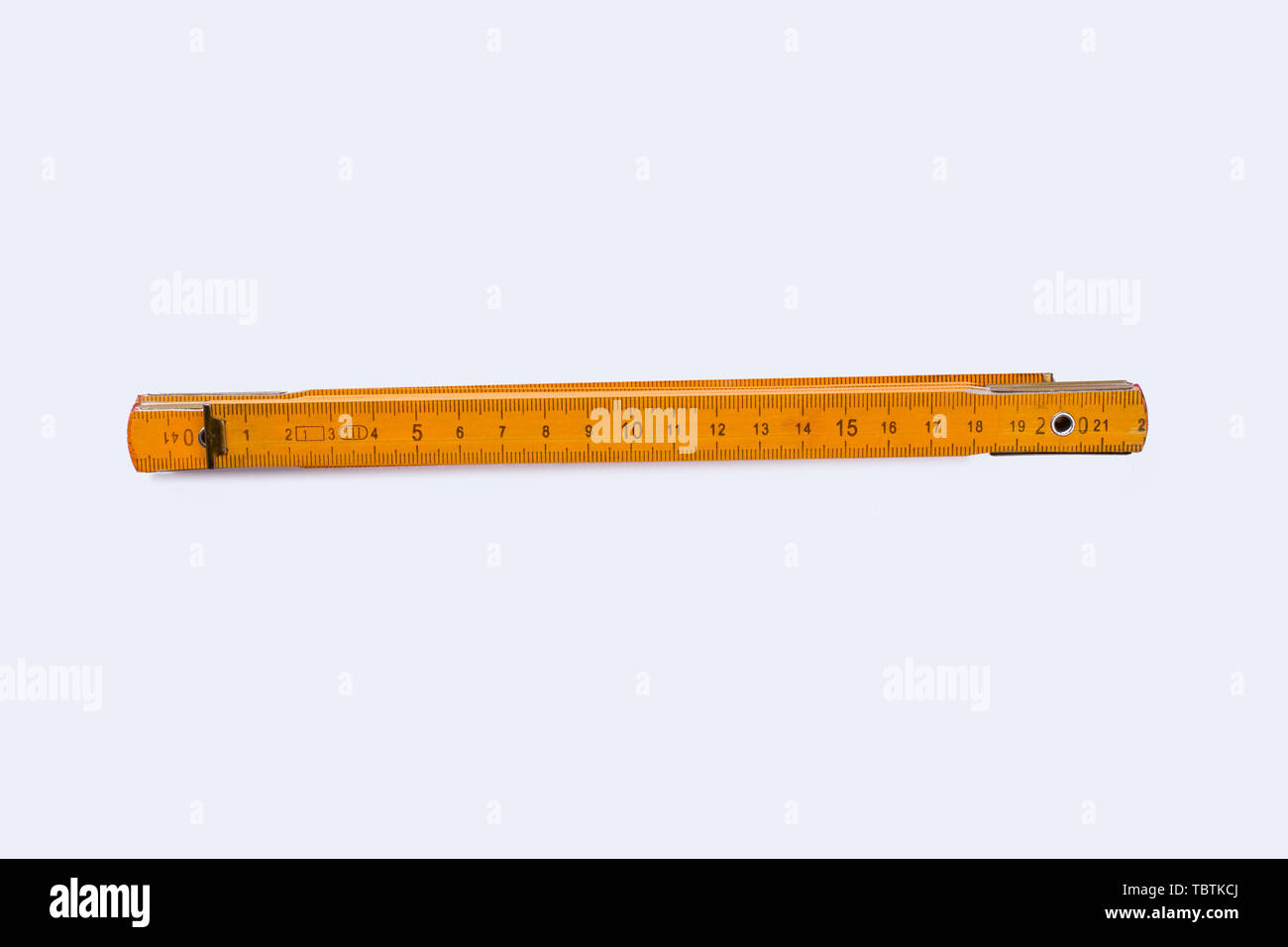 Yellow folding ruler isolated on white background. Wooden measuring ...
