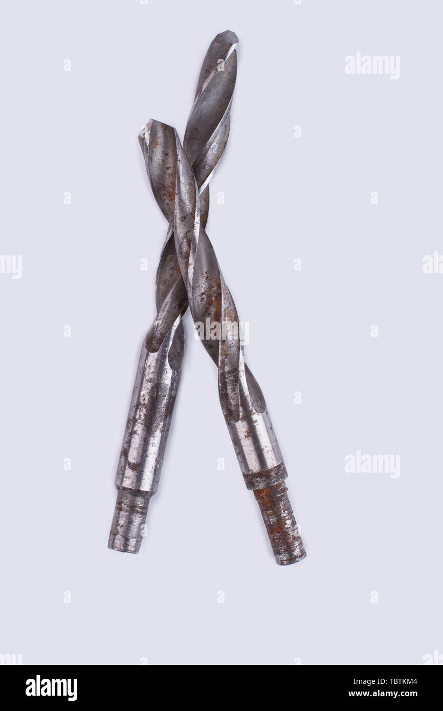 Rusty drill bits over white background. Two old drill bits, vertical ...