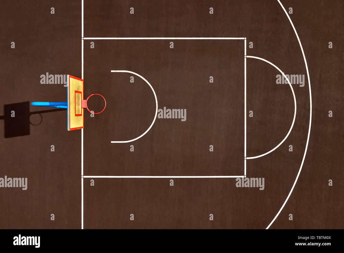 Outdoor brown basketball field with white lines and curves and colorful ...