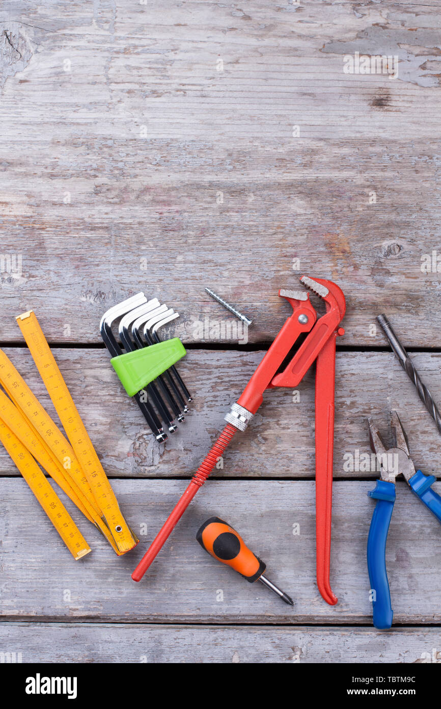 Construction tools on wood background. Cracked wooden surface with ...