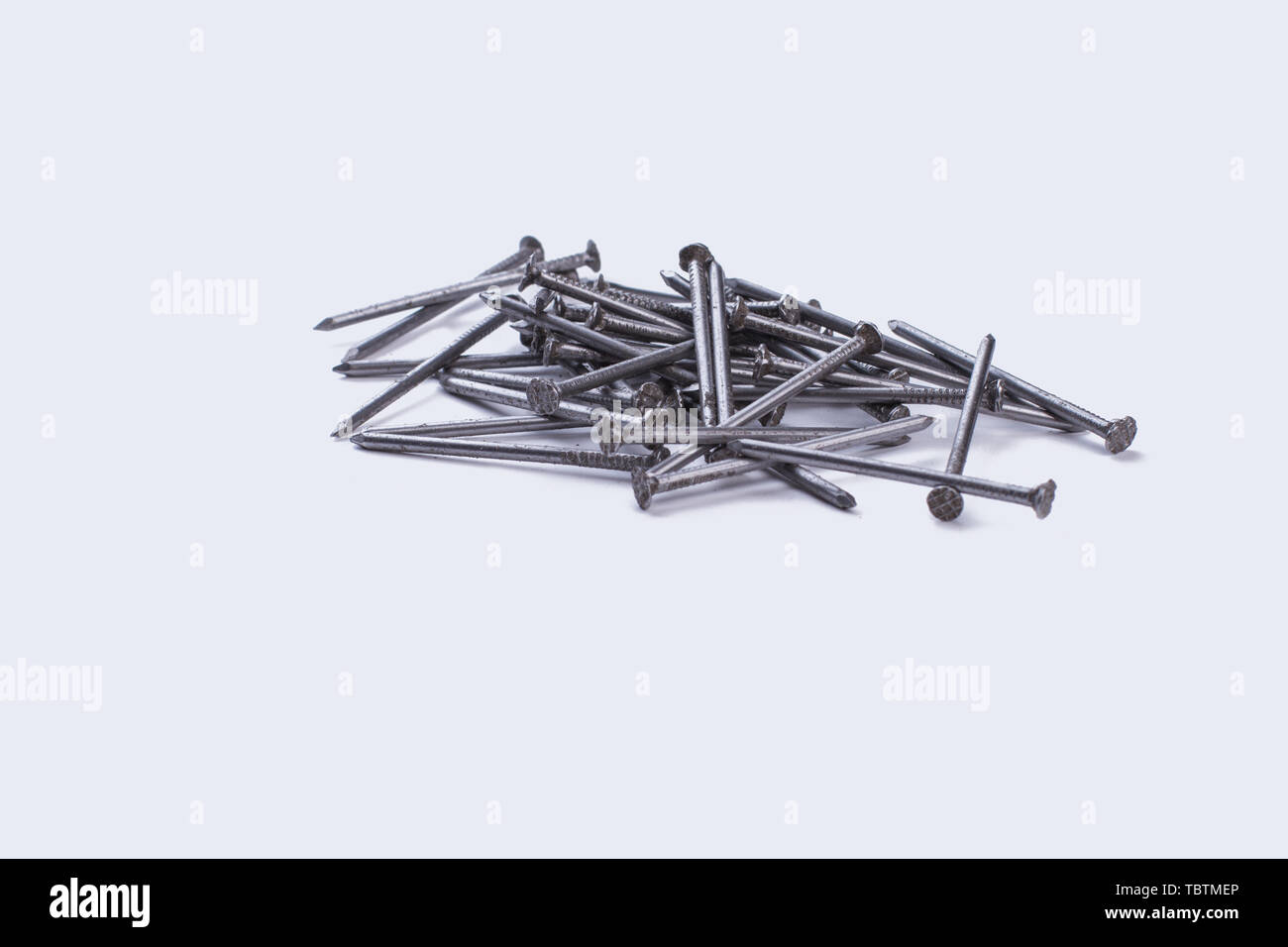 Heap of metal nails on white background. Pile of iron nails ...