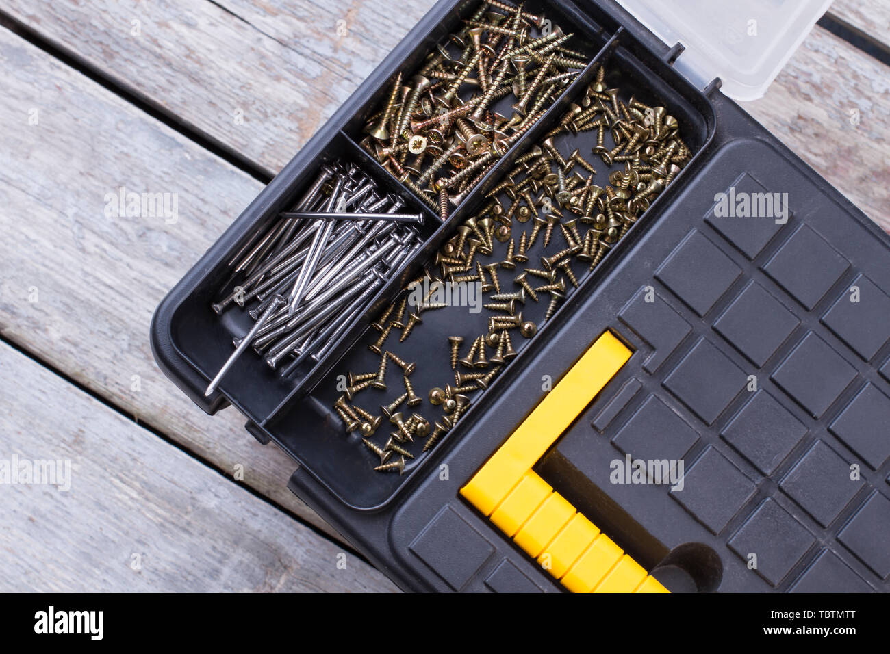 Screws and nails in plastic box. Plastic organizer box with wood screws ...