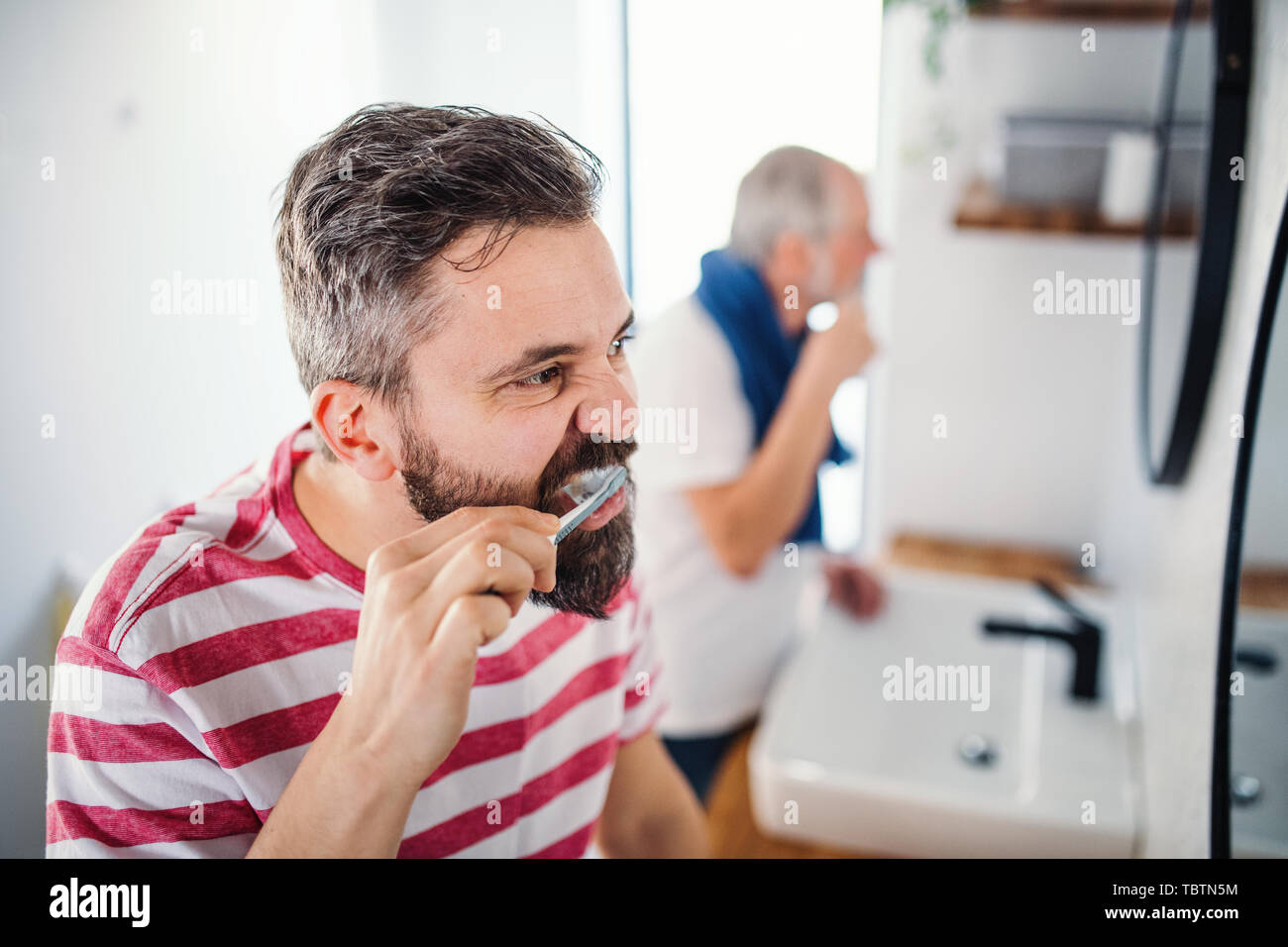 Male adult brushing teeth hi-res stock photography and images - Alamy