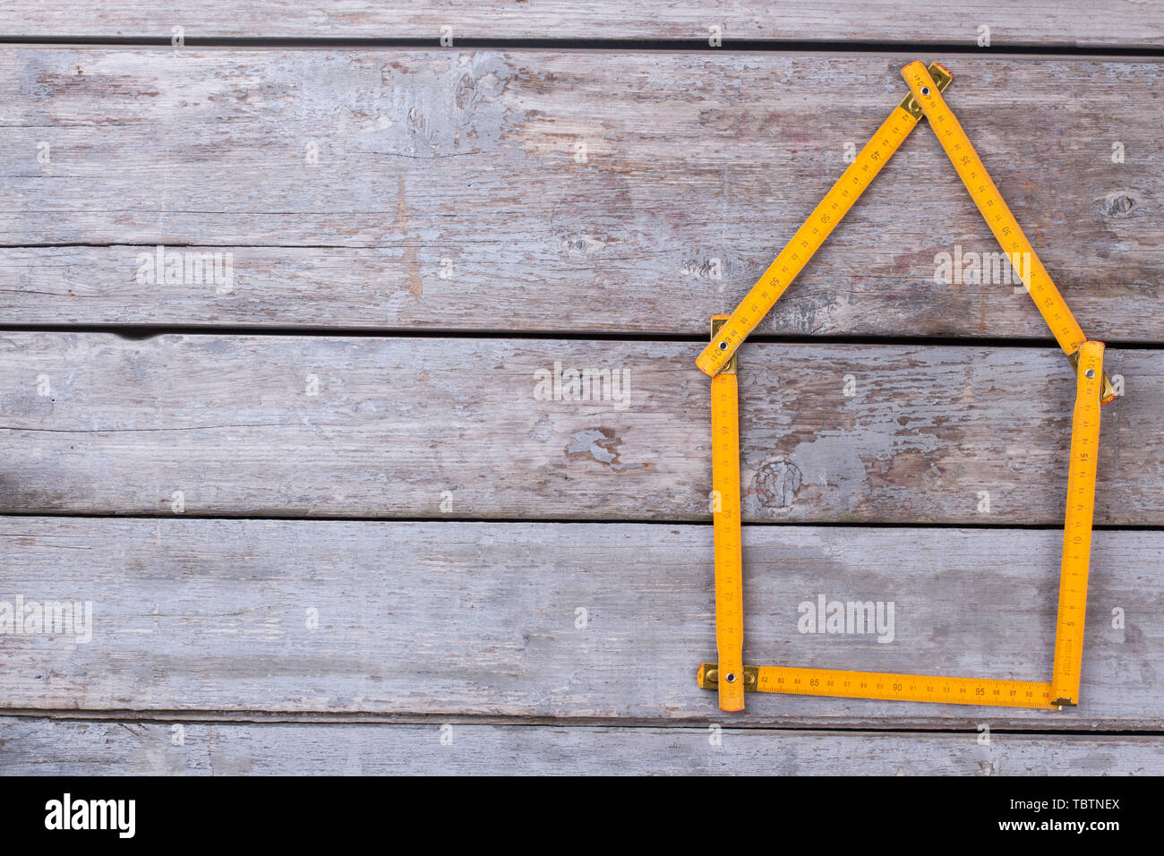 Meter rule folded in form of a house. House shape made from folding ...