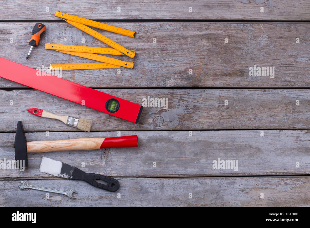 Working tools on wooden background. Tool kit including spatula, hammer ...