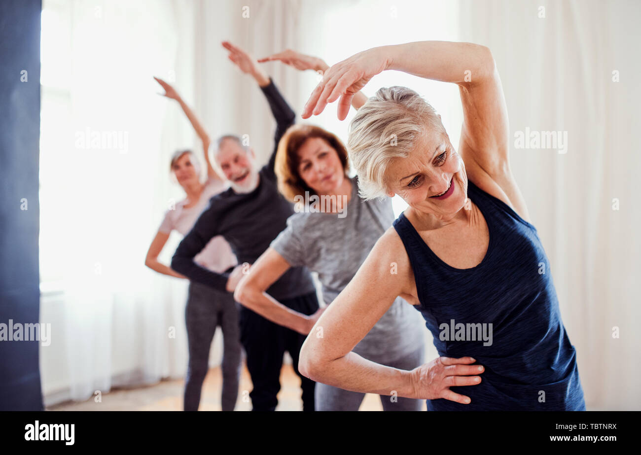 Group of senior people doing exercise in community center club Stock ...