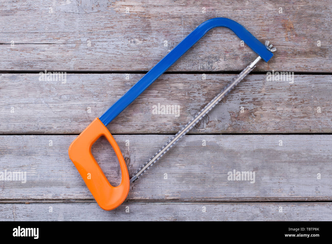 Hand saw on vintage wooden background. Saw on rustic wooden boards ...