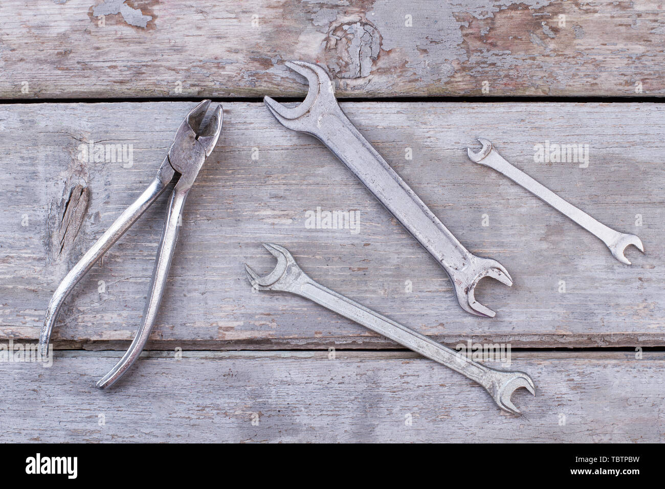 Steel construction instruments on wooden background. Steel wrench and ...