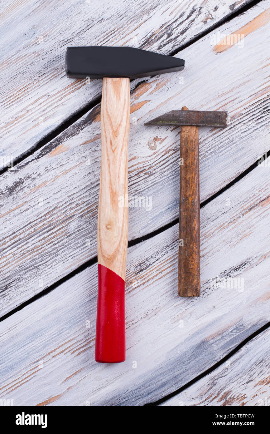 Hammers on wooden background, top view. Big and small hammers on wooden ...