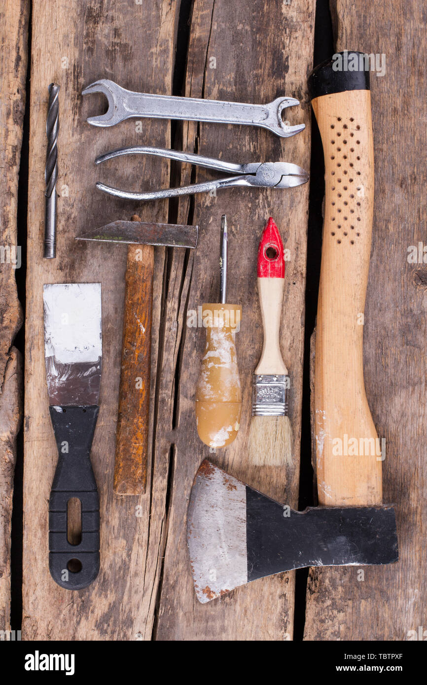 Old rusty tools on a wooden boards background. Variety of hand tools ...