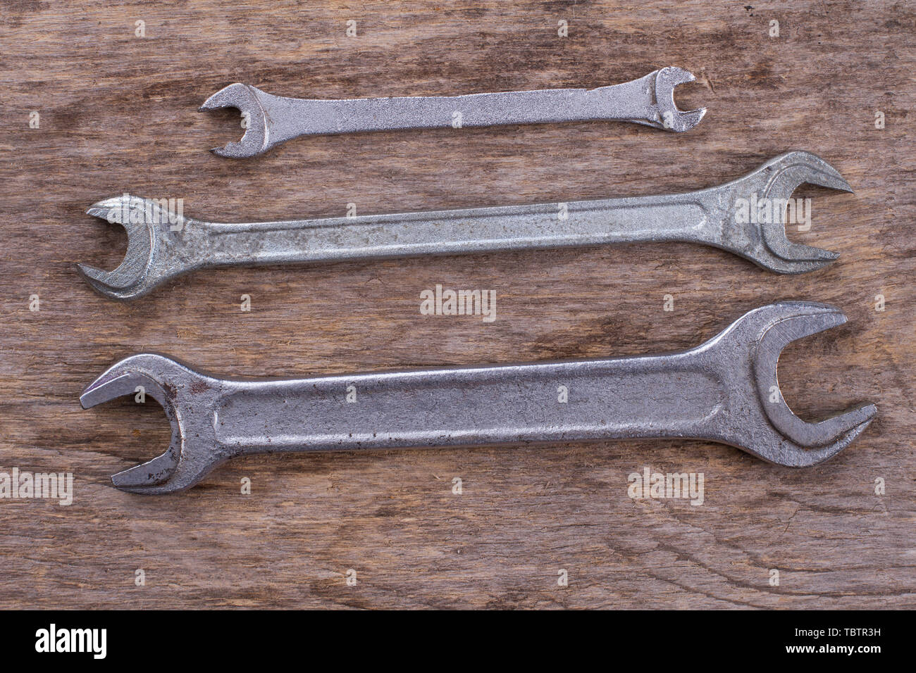Wrenches on wooden background. Repair carpenter tools Stock Photo - Alamy